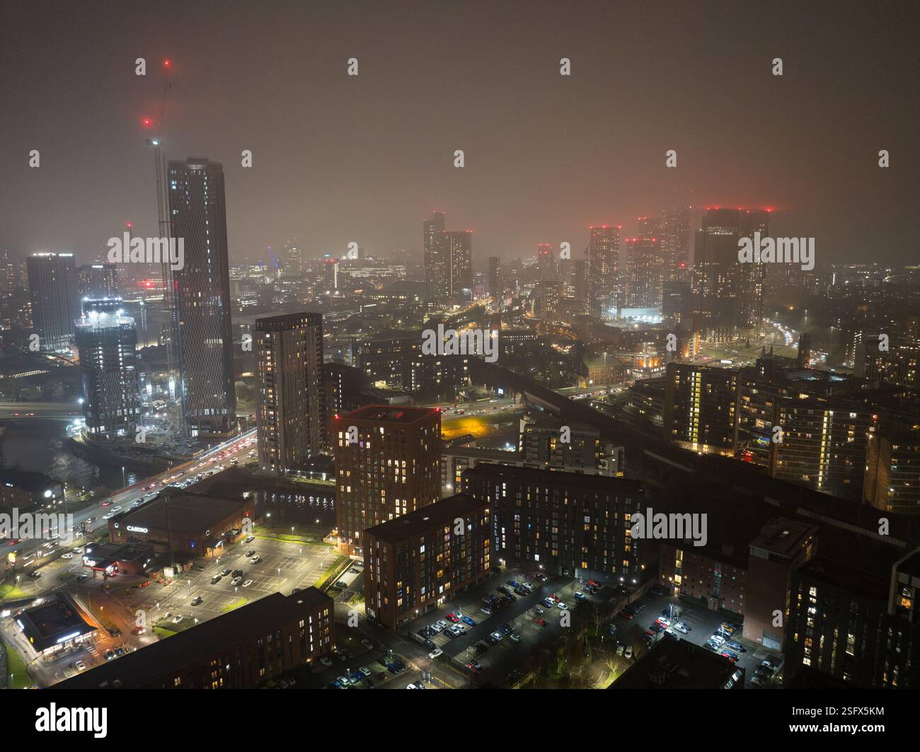 Illuminated high-rise buildings in Manchester city center during dusk ...