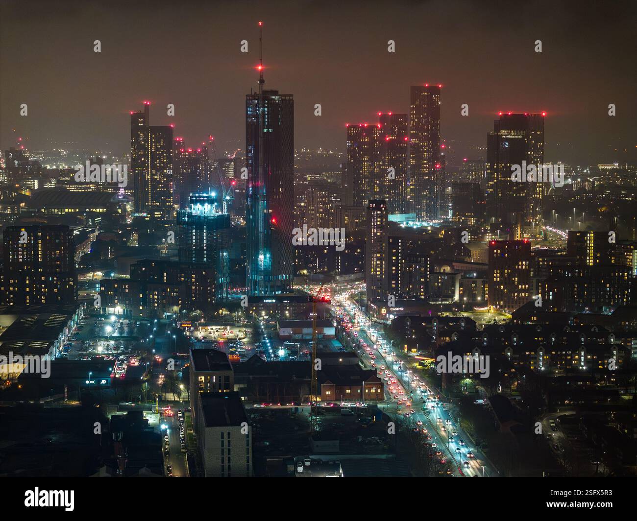 A nocturnal capture of Manchester city center showing illuminated ...
