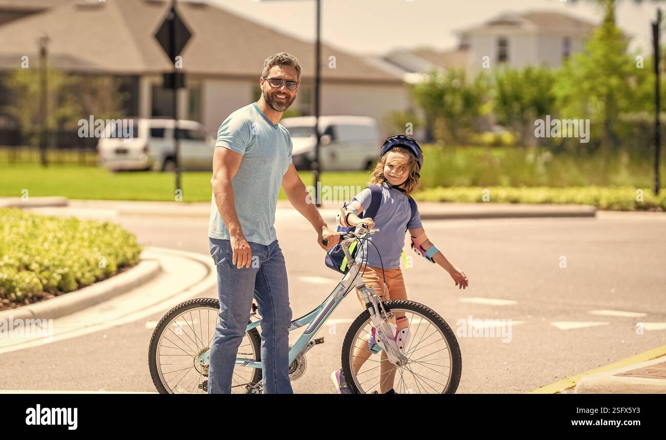 father and son on bicycle at fathers day. active father setting a ...