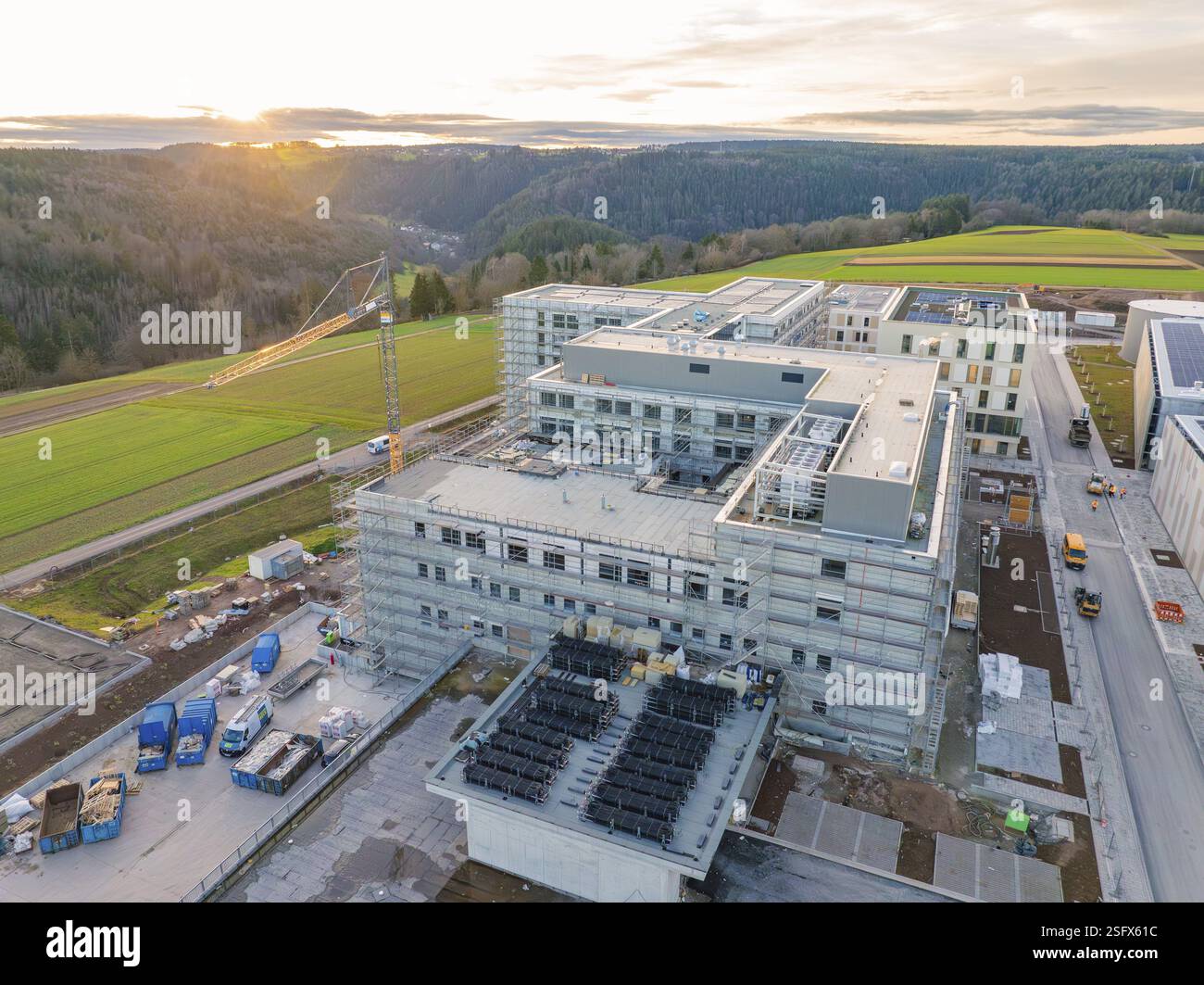 Large-scale project with construction crane and scaffolding in a hilly ...