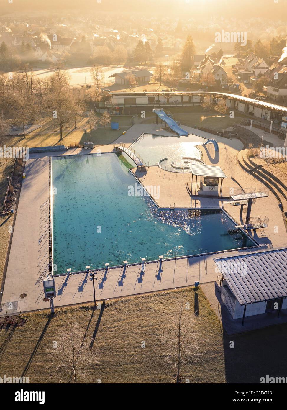 Aerial view of an outdoor swimming pool with clear pools in urban ...