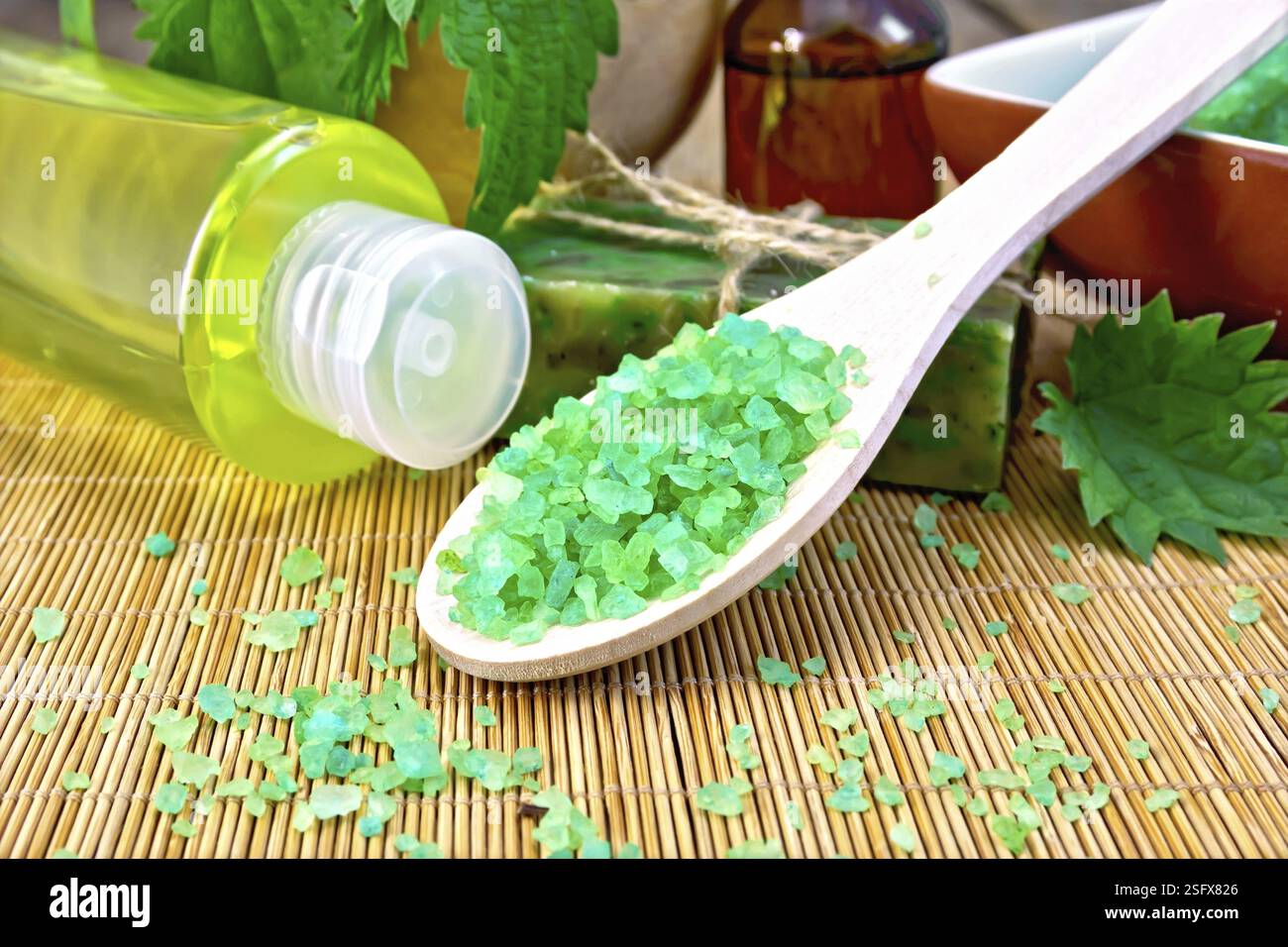Green salt, shampoo, oil, gel, soap with nettles in a mortar on a ...
