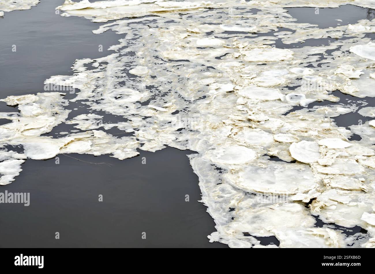 Dirty crushed ice in the dark water Stock Photo - Alamy