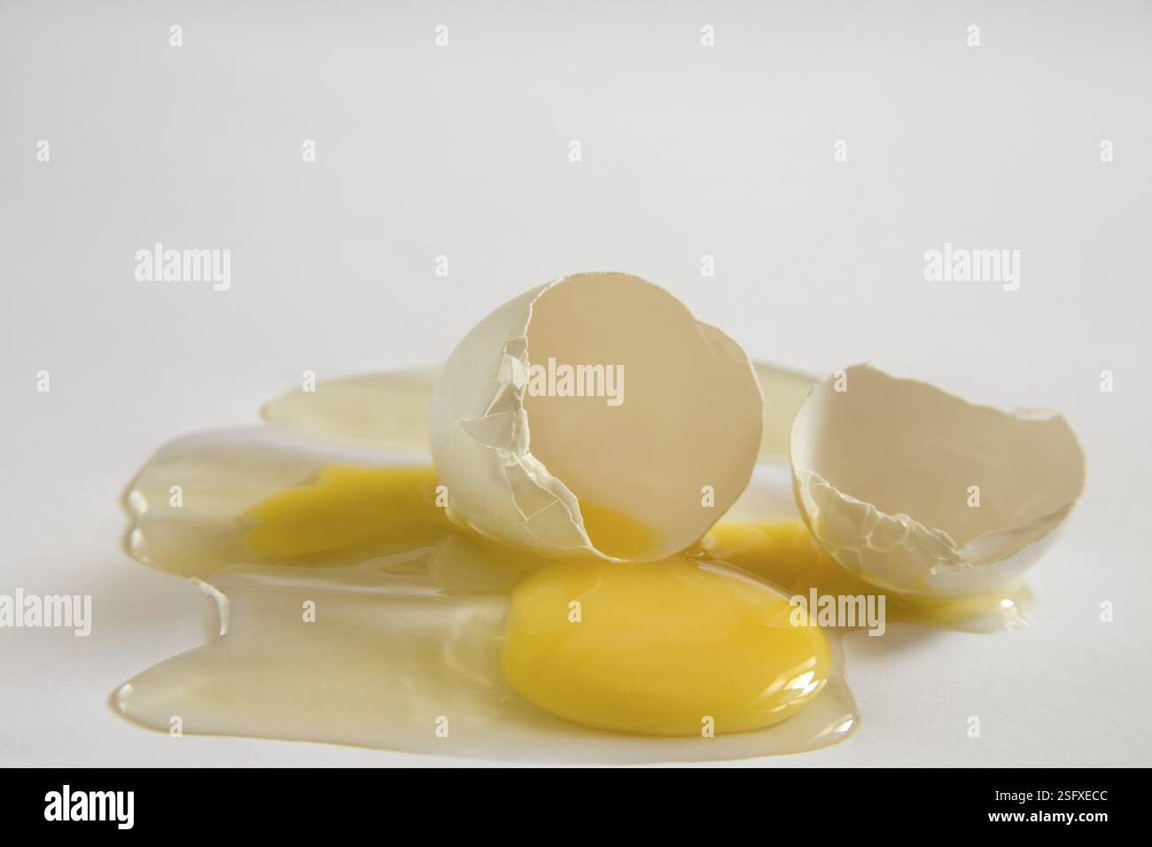 Concept, anda broken egg yolk death destroy life end on white ...