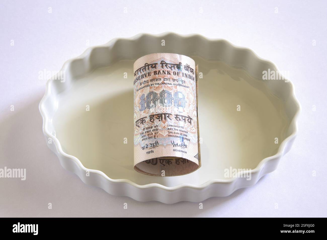 Concept, Indian currency one thousand rupees in bowl Stock Photo - Alamy