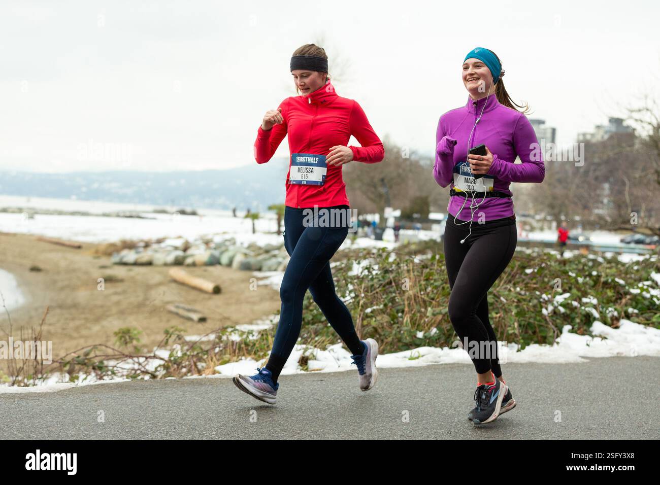 Vancouver, Canada - 9 Feb, 2025. Runners along the sea wall with snow ...