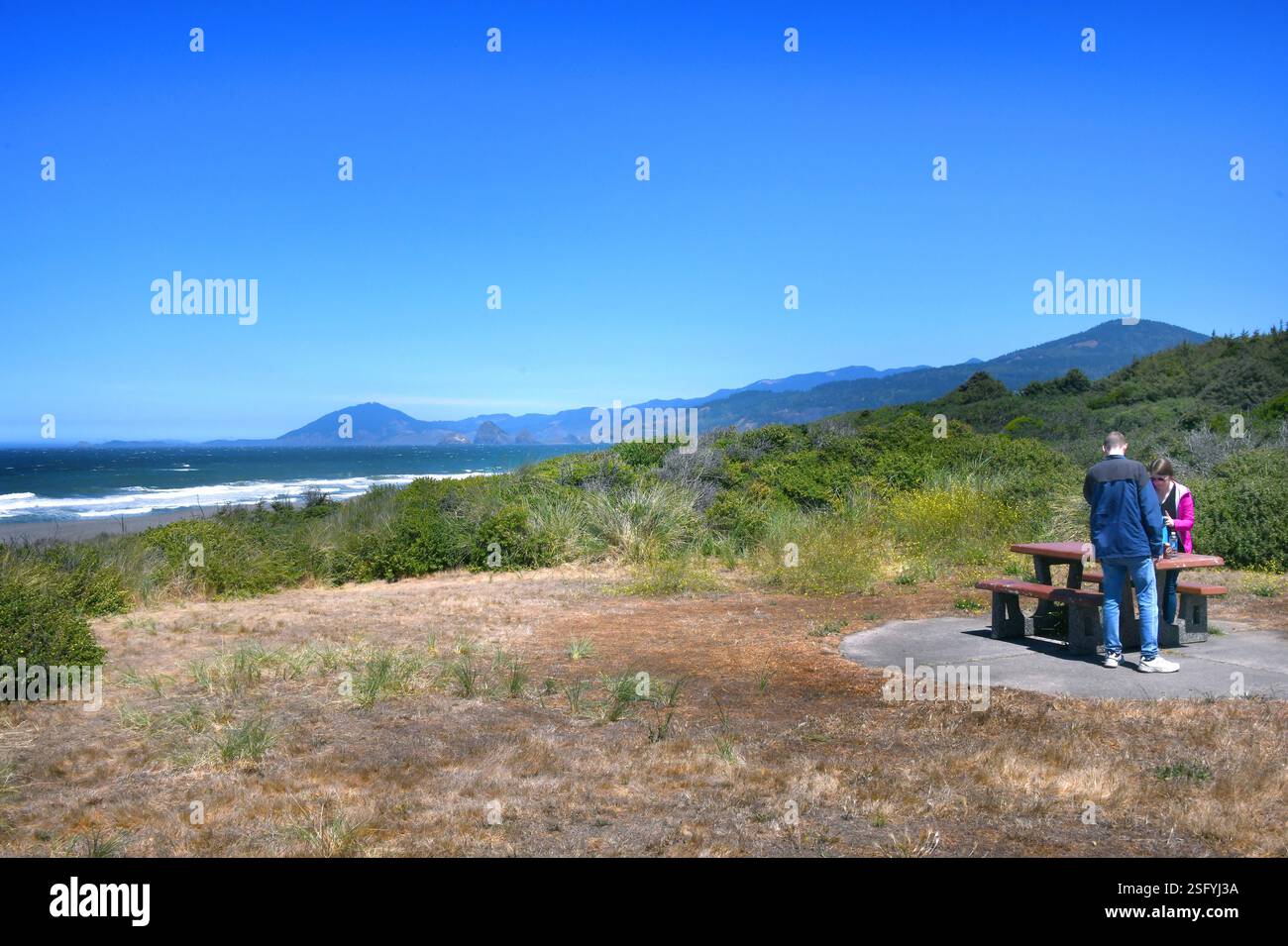 Two young people stop to enjoy the Ophir Wayside State Park Rest Area ...