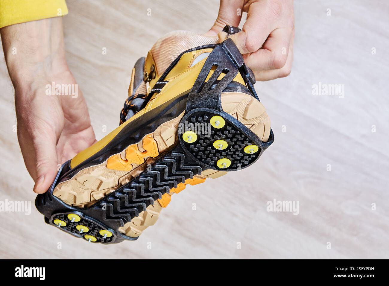 Attaching ice cleats to a hiking boot for better traction on slippery ...