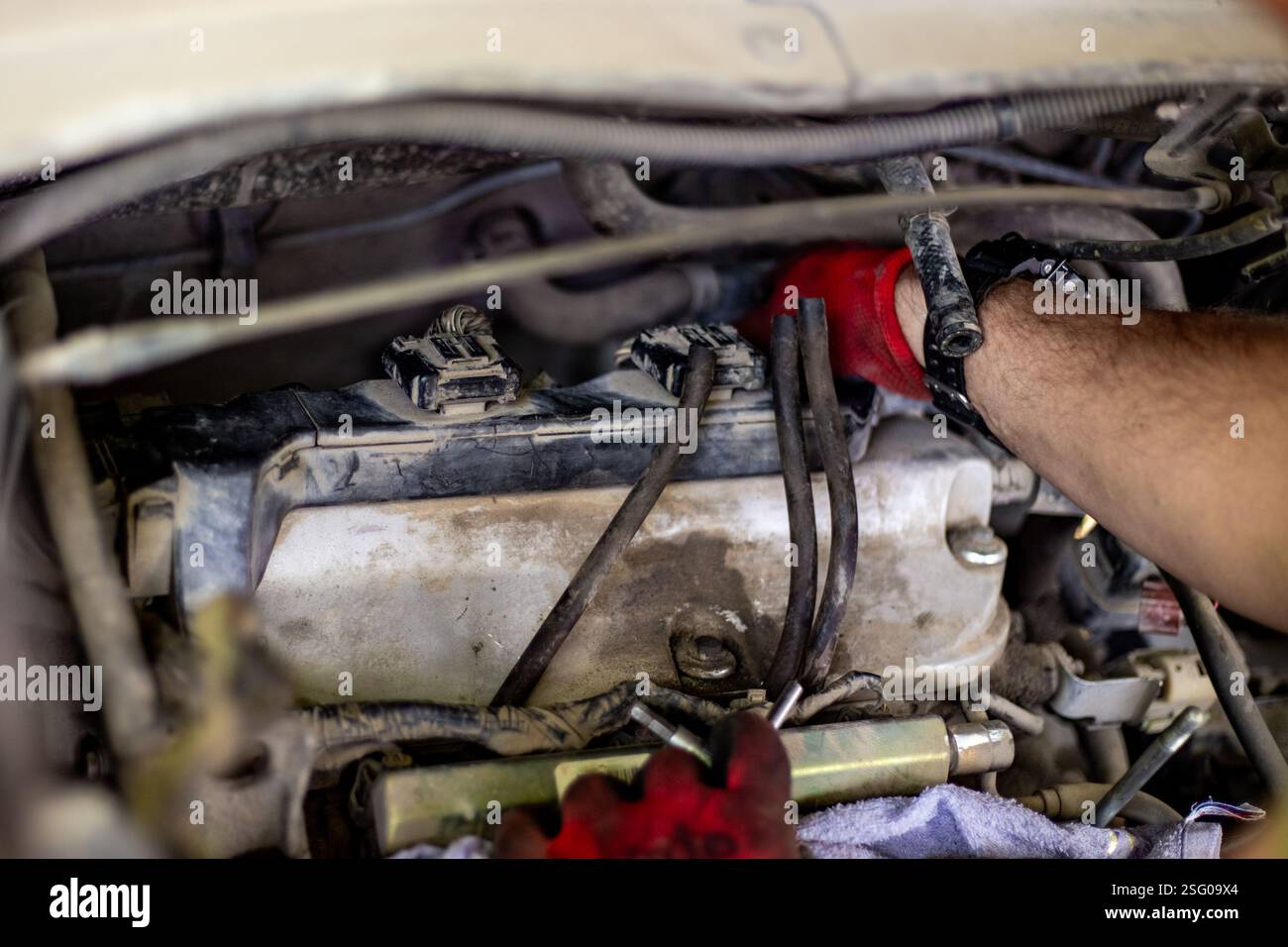 Car repair. Installing a conductor on a spark plug Stock Photo - Alamy