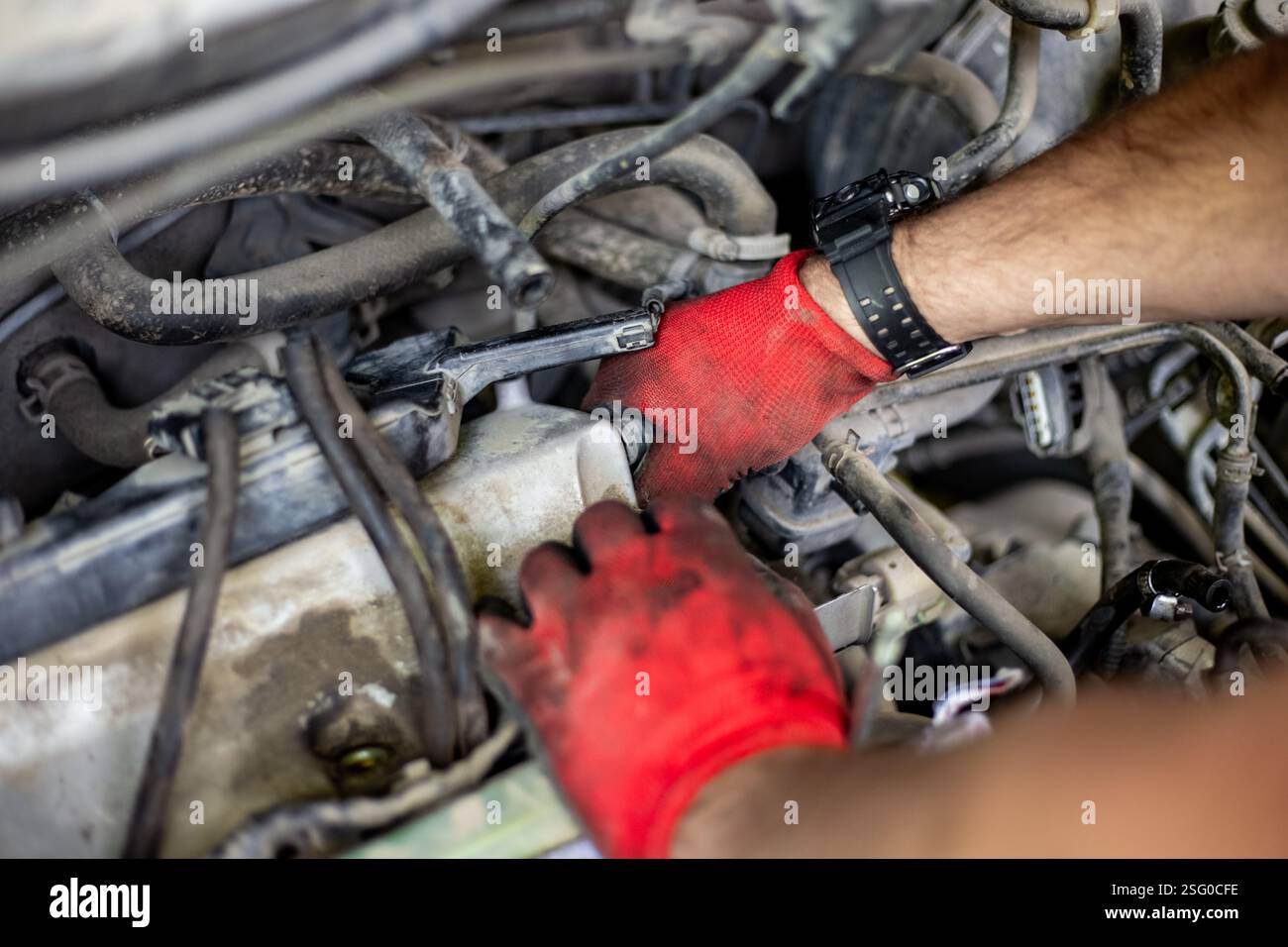 Car repair. Mechanic removes the engine crankcase gas recirculation ...