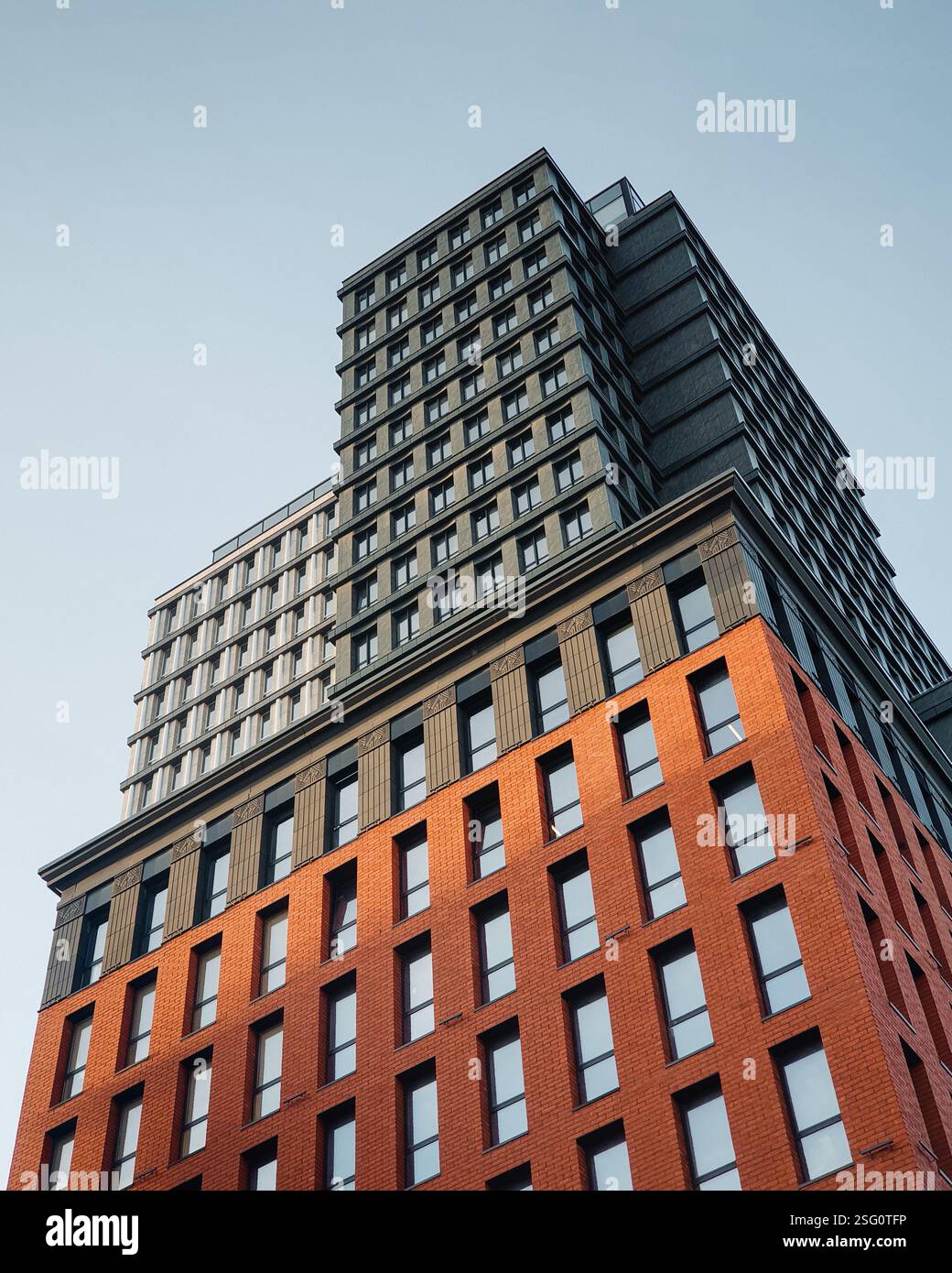 Stylish high-rise residential building at sunset against clear blue sky ...