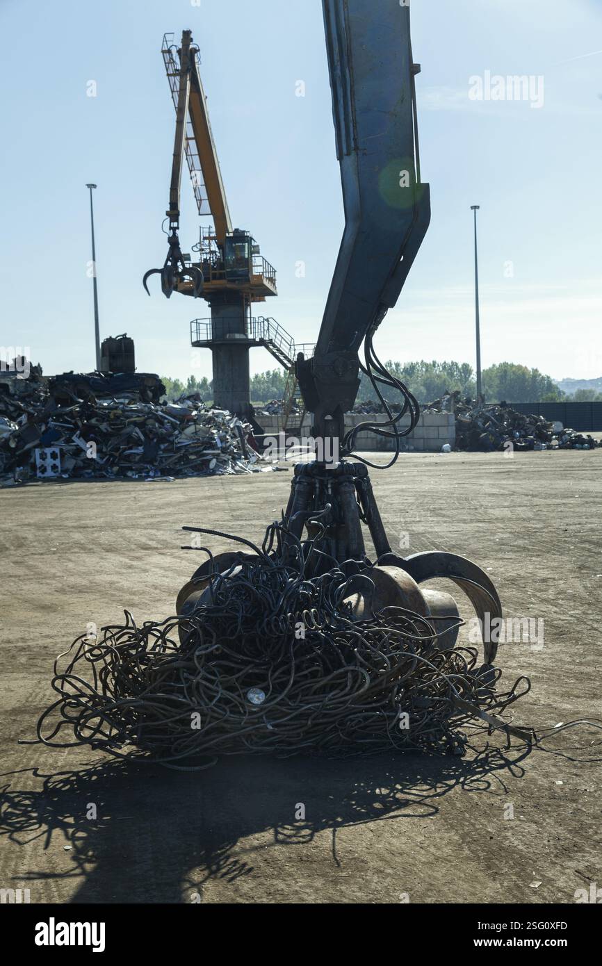 Large excavators work on scrap metal for recycling, sunny day Stock ...