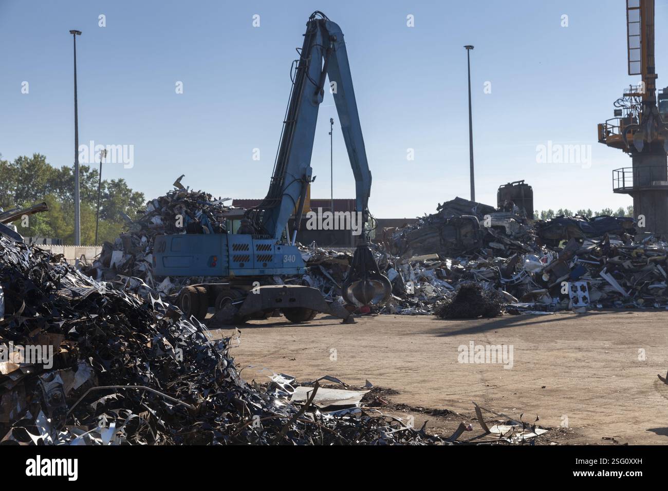 Large excavators work on scrap metal for recycling, sunny day Stock ...