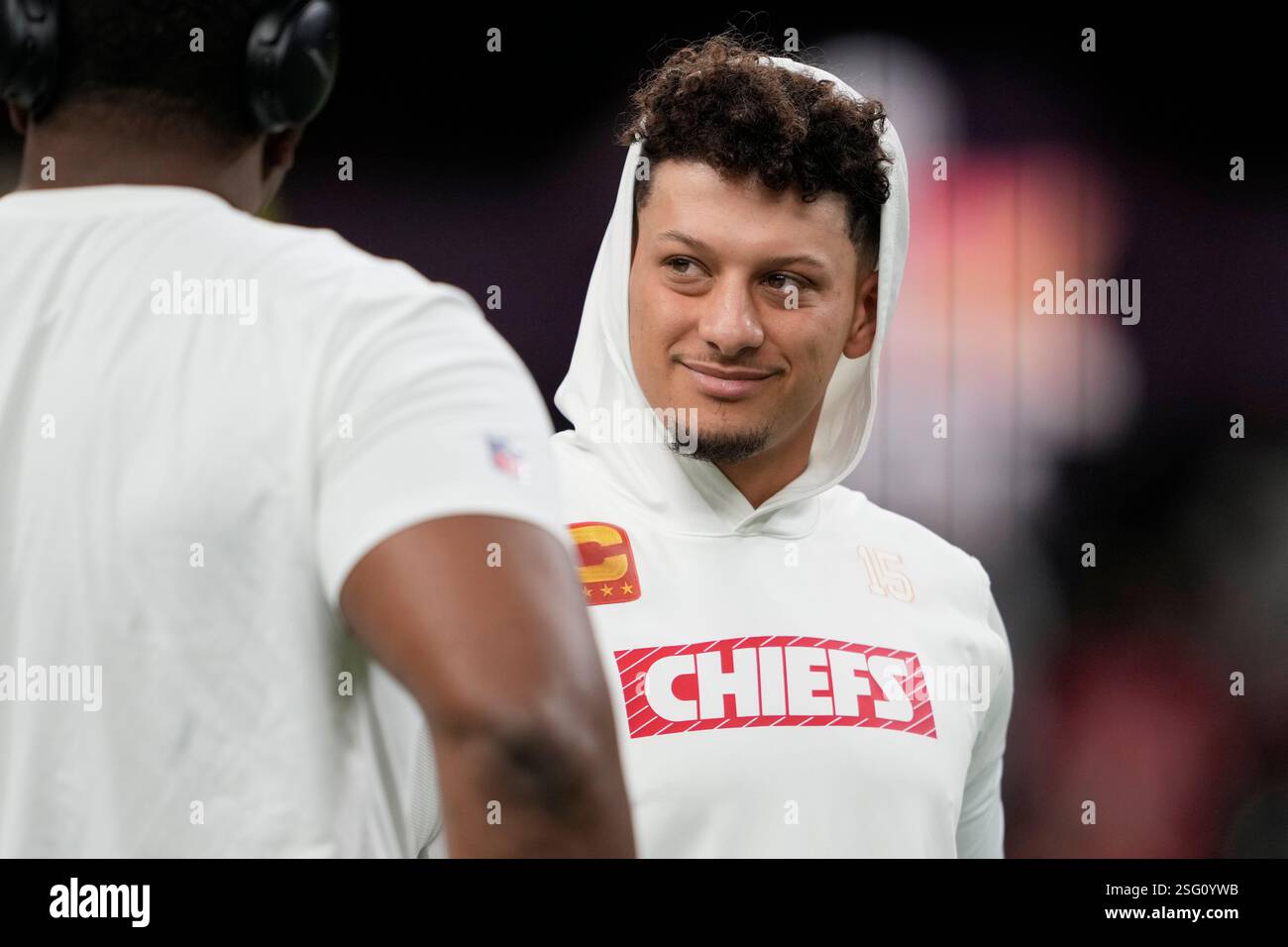 Kansas City Chiefs quarterback Patrick Mahomes talks with a member of ...
