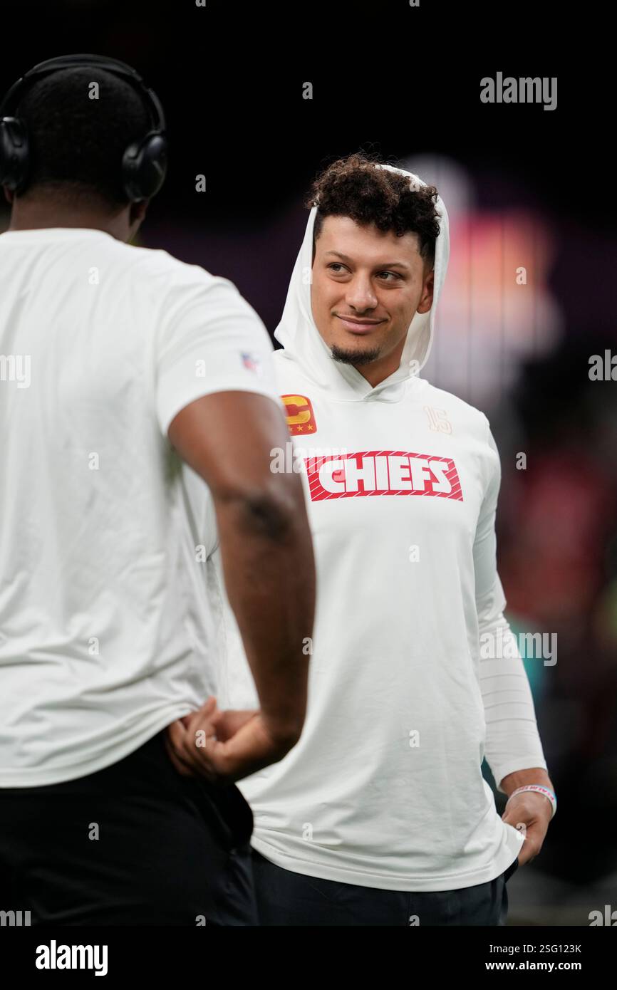 Kansas City Chiefs quarterback Patrick Mahomes talks with a member of ...