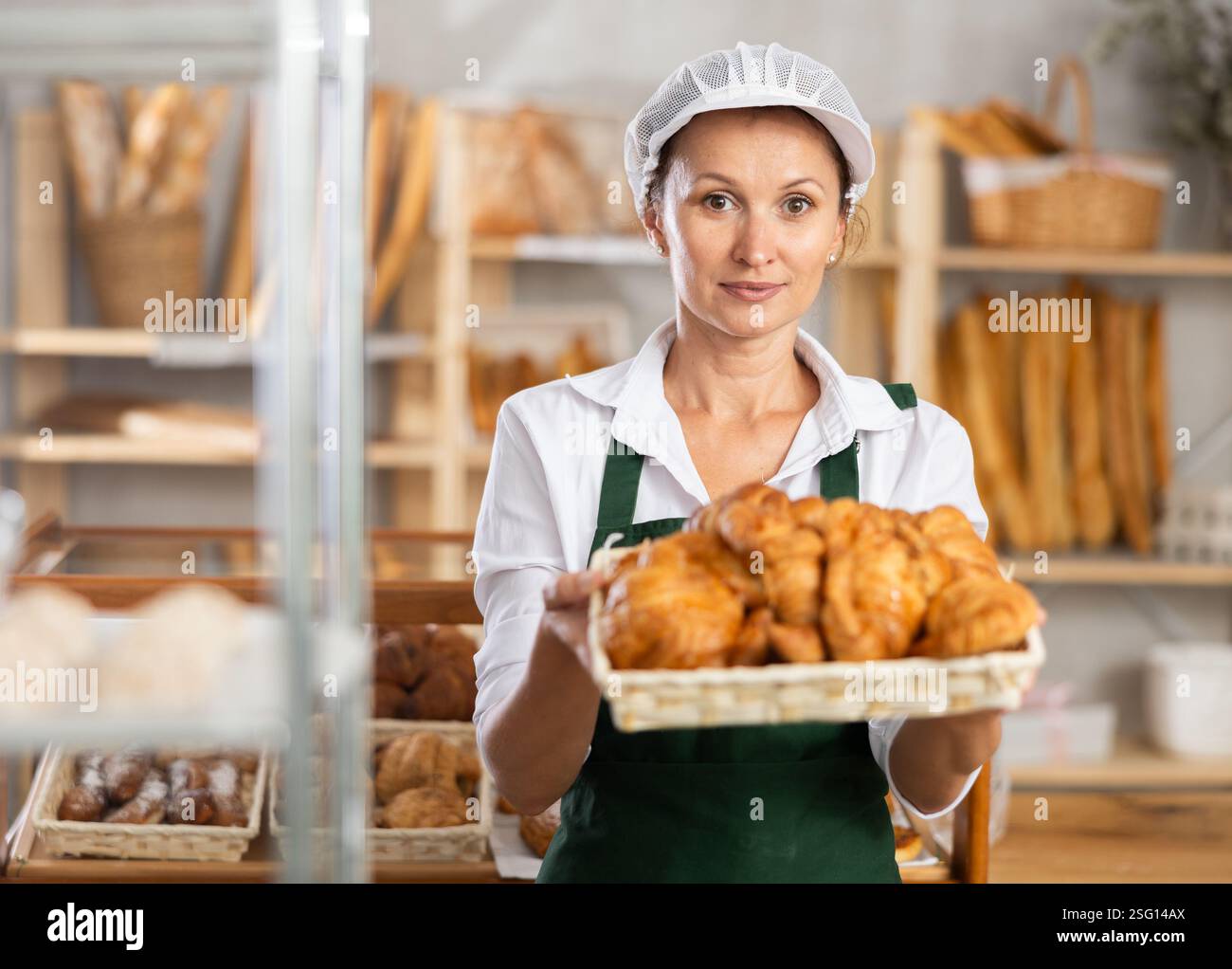 bakery worker shows off a variety of different crescent-shaped buns ...