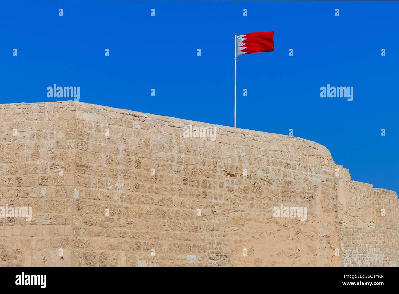 The Bahraini flag flying proudly over Qal'at al-Bahrain also known as ...