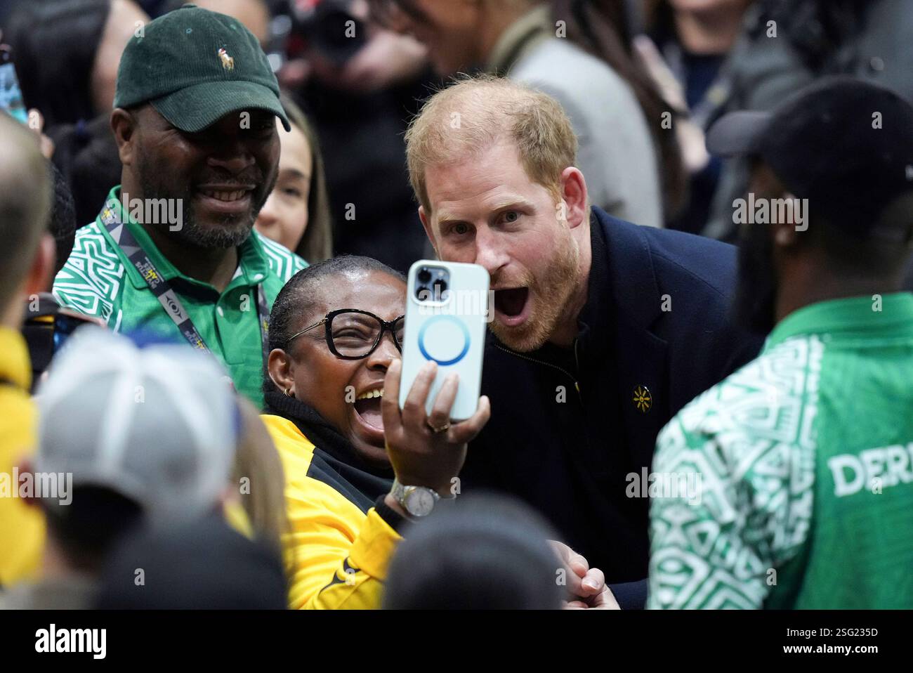 Britain's Prince Harry poses for a photograph with a spectator after he ...