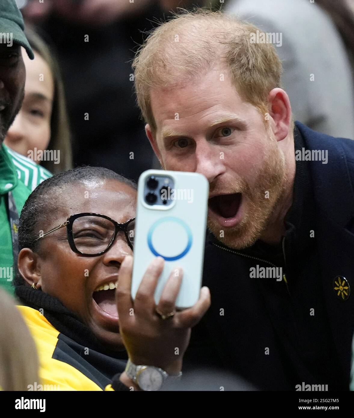 Britain's Prince Harry poses for a photograph with a spectator after he ...