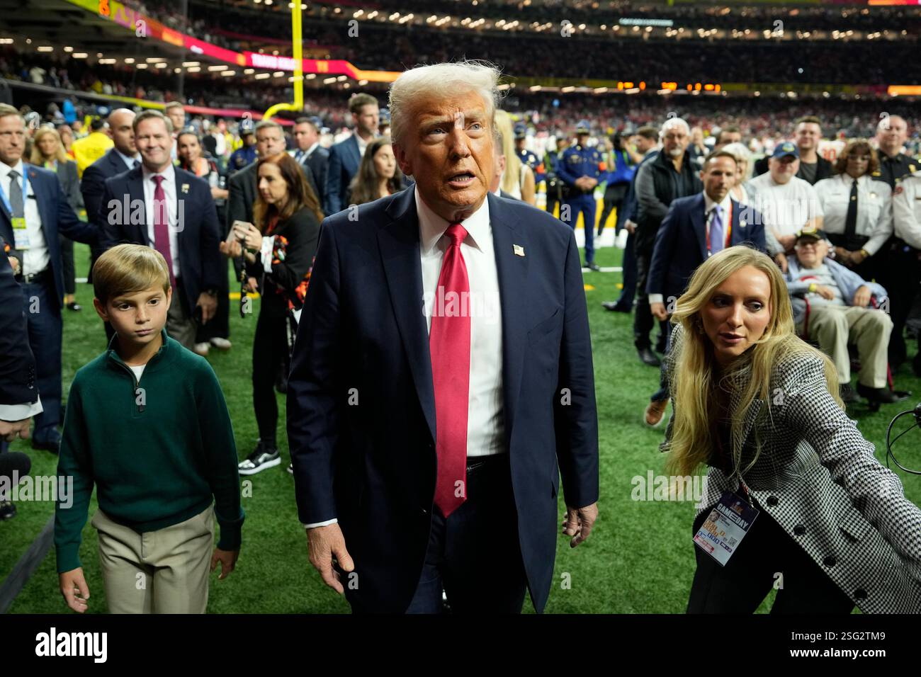 President Donald Trump, center, with his grandson Theodore, left walks ...
