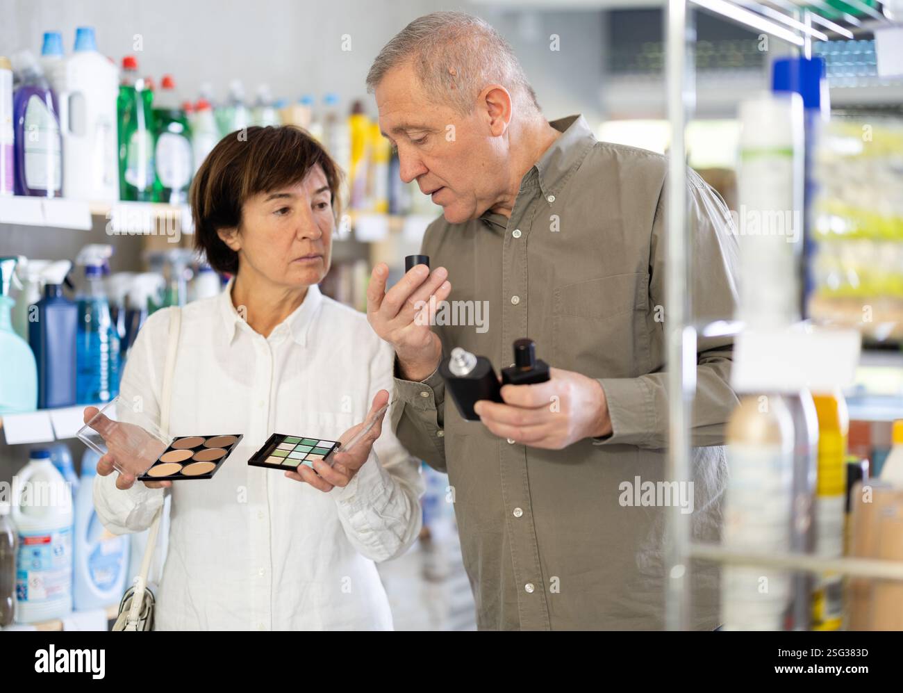 Couple man and woman choosing perfume and cosmetics Stock Photo - Alamy