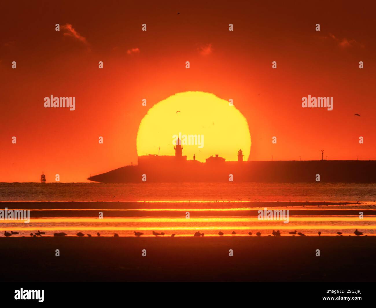 Sunrise lined up with Dún Laoghaire lighthouses from Sandymount Strand ...