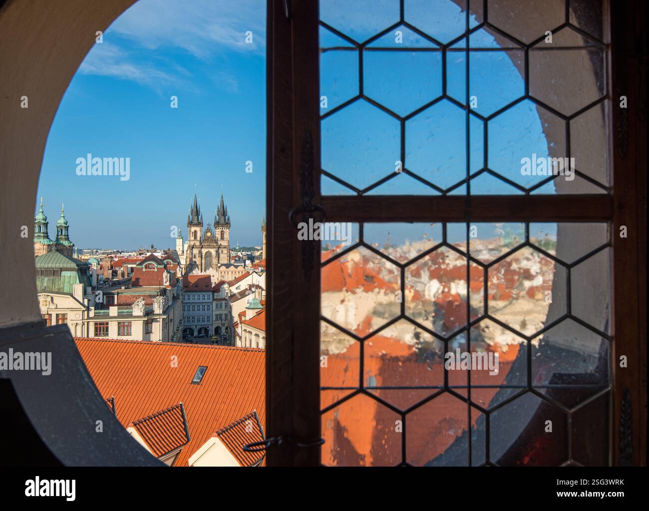 View of Prague rooftops and church towers from a circular window Stock ...