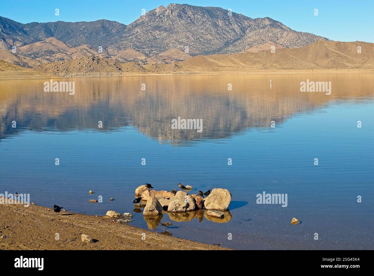 Reflection of barren hills on shallow waters of Owens Lake in Mojave ...