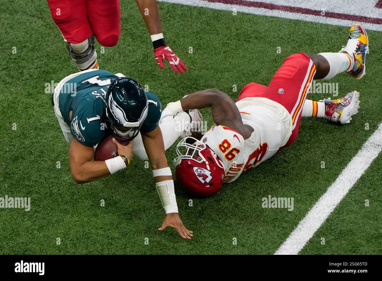 Philadelphia Eagles quarterback Jalen Hurts (1) is tackled by Kansas ...