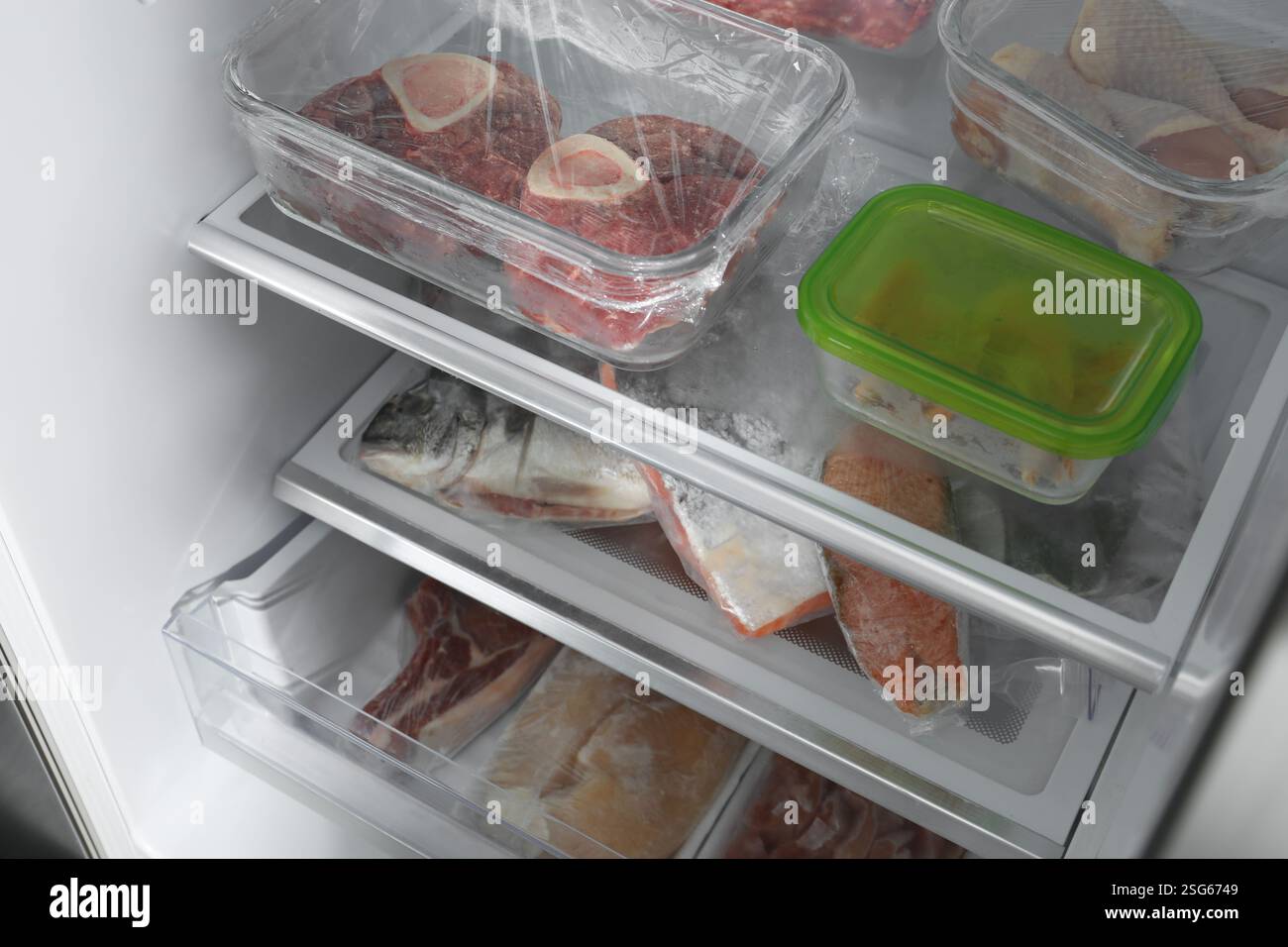 Different frozen meat and fish products in fridge, closeup Stock Photo ...