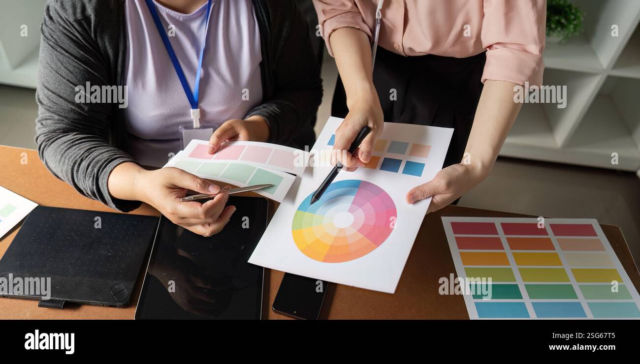 Graphic design team reviewing color palettes and materials in a ...