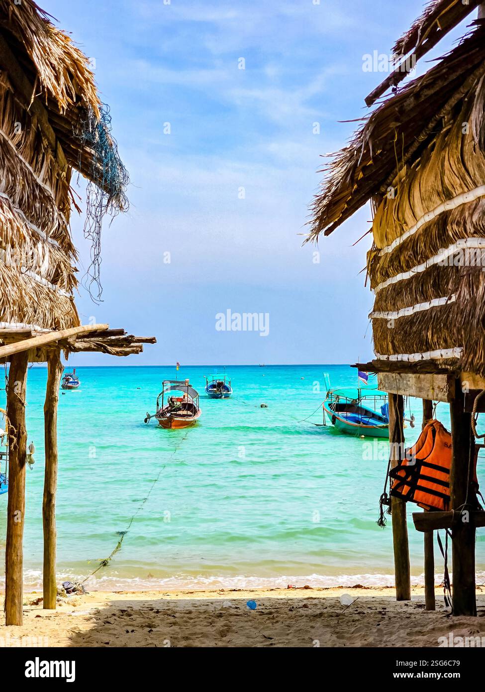 A breathtaking vista unfolds between two thatched huts, revealing the ...