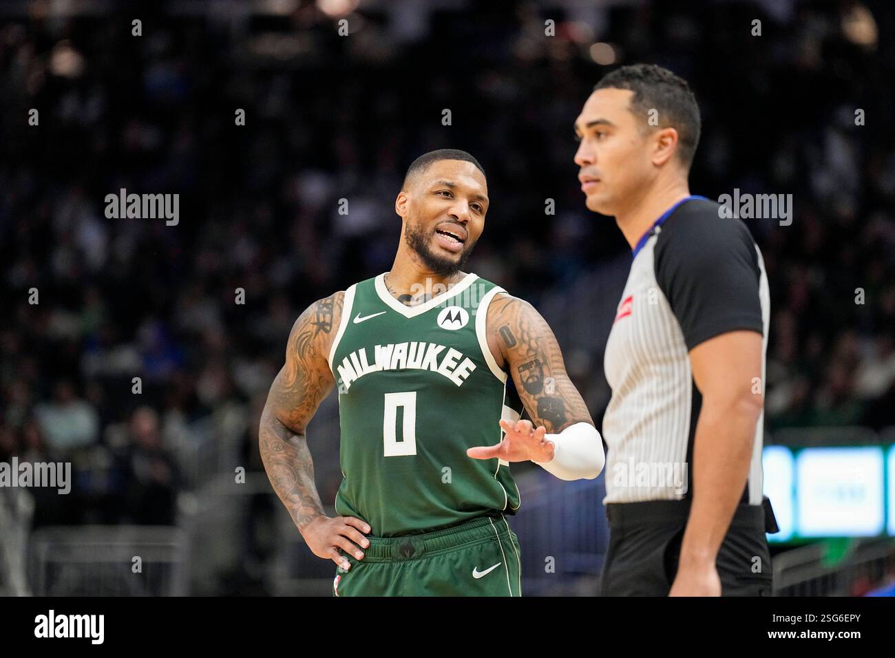Milwaukee Bucks' Damian Lillard (0) talks with official John Conley ...
