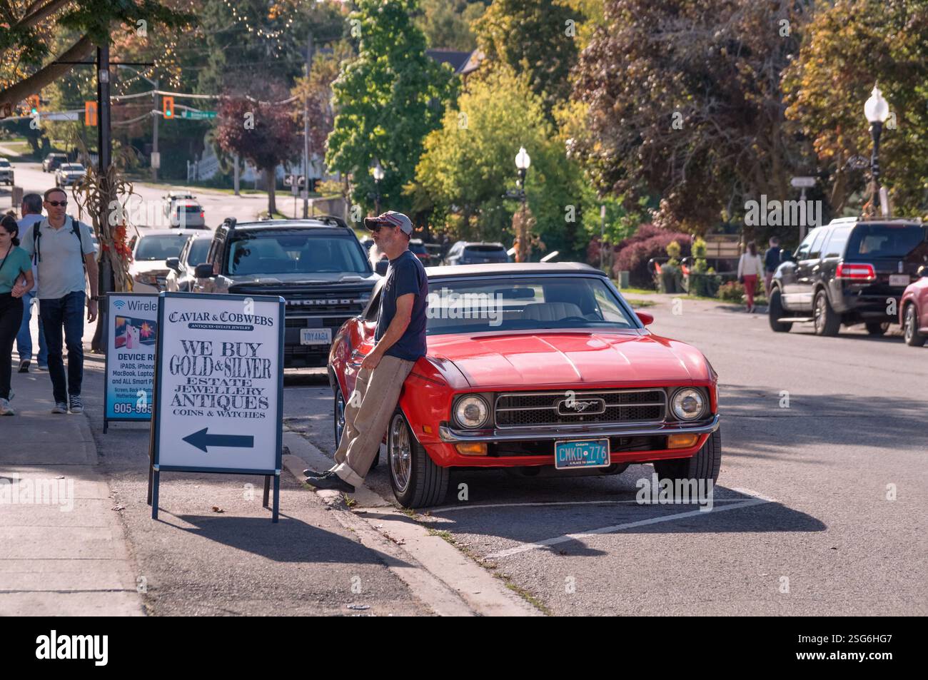 Port Perry, Ontario, Canada - 2024 10 05: Owner of a vintage muscle car ...