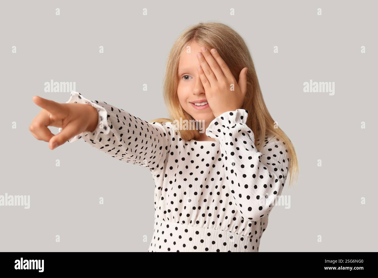 Teenage girl checking her eyesight on light background. Children's Eye ...