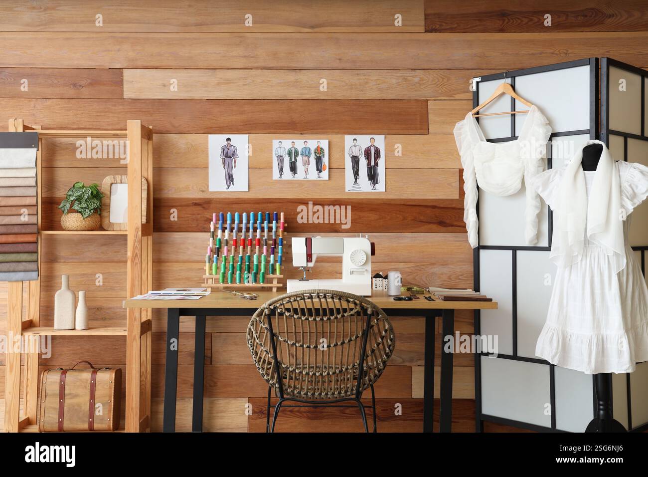 Interior of atelier with tailor's workplace, mannequin and shelf unit ...