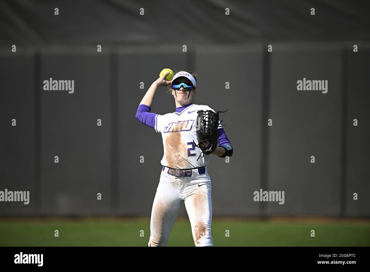 James Madison outfielder Raegan Wall (2) throws during an NCAA college ...