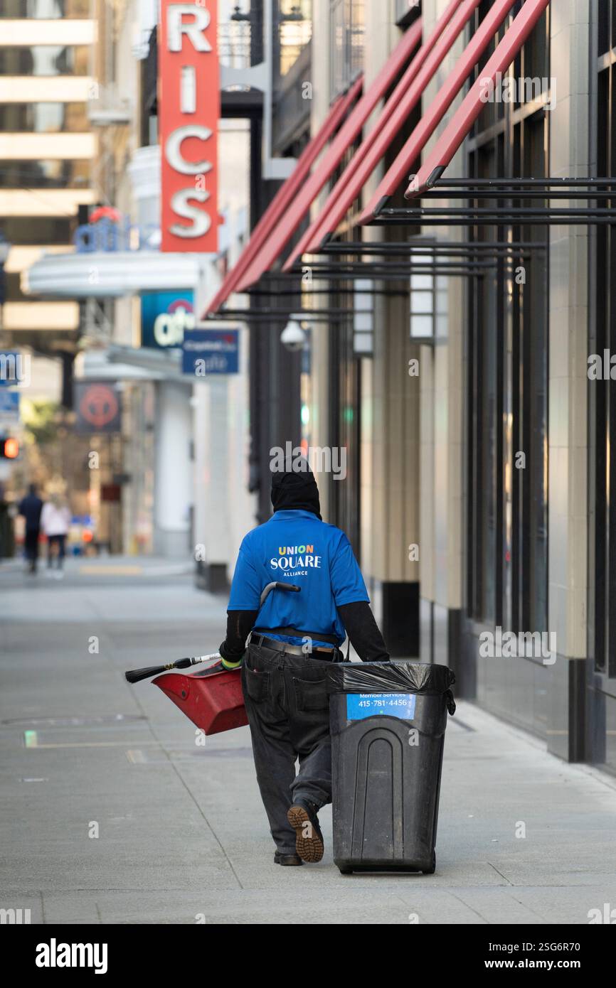 Union Square Alliance worker collecting trash on a city street near the ...