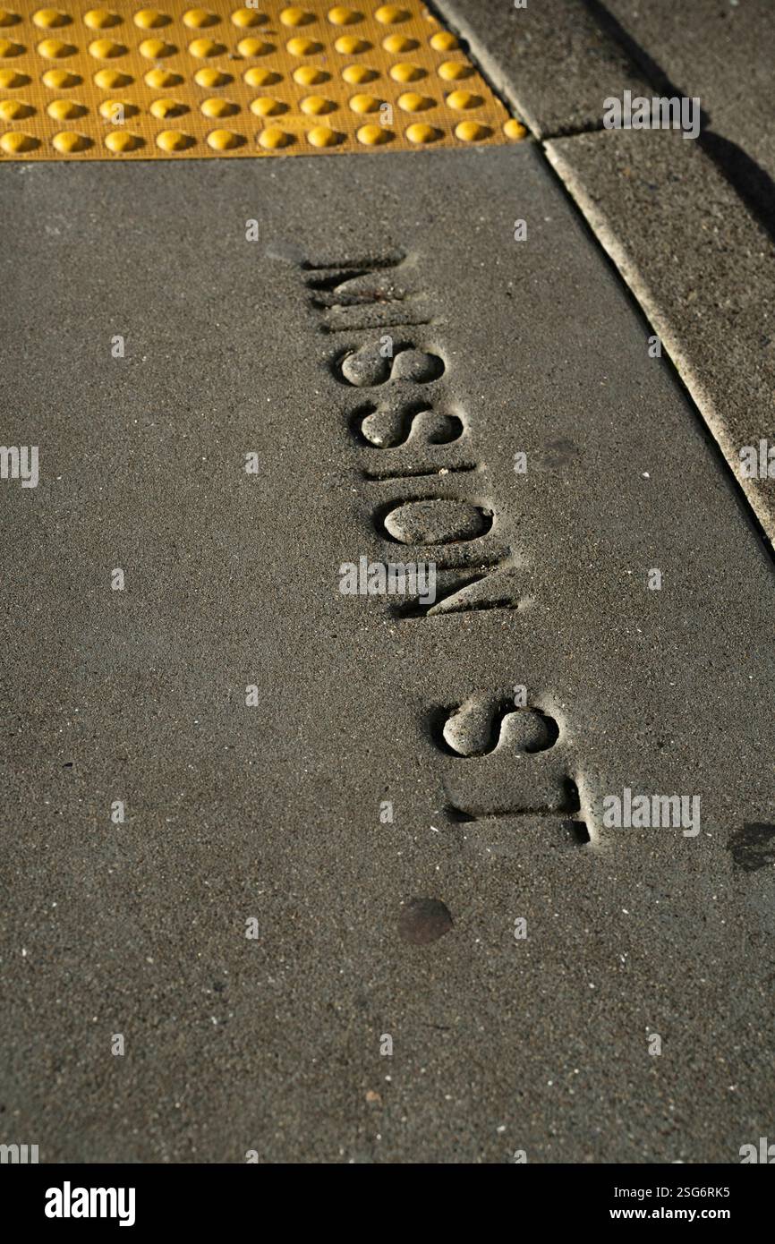 Mission St. curb, San Francisco. Street name etched into sidewalk Stock ...