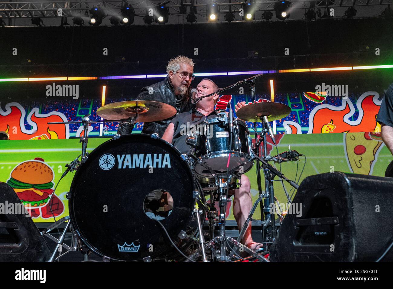 Guy Fieri, let, on stage with Fred LeBlanc of Cowboy Mouth during Guy ...