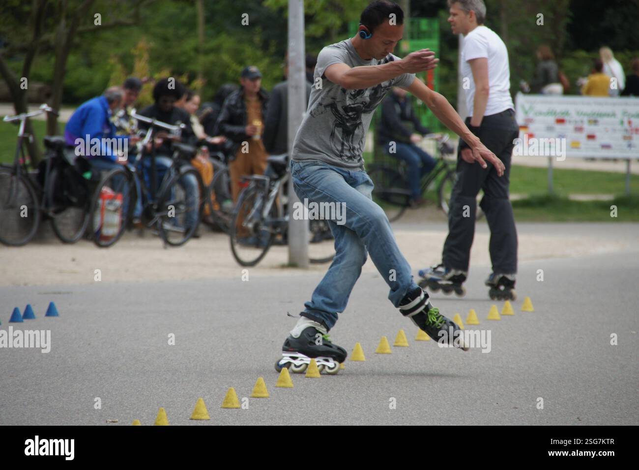 Roller skater glide smoothly along the streets of Amsterdam, weaving ...