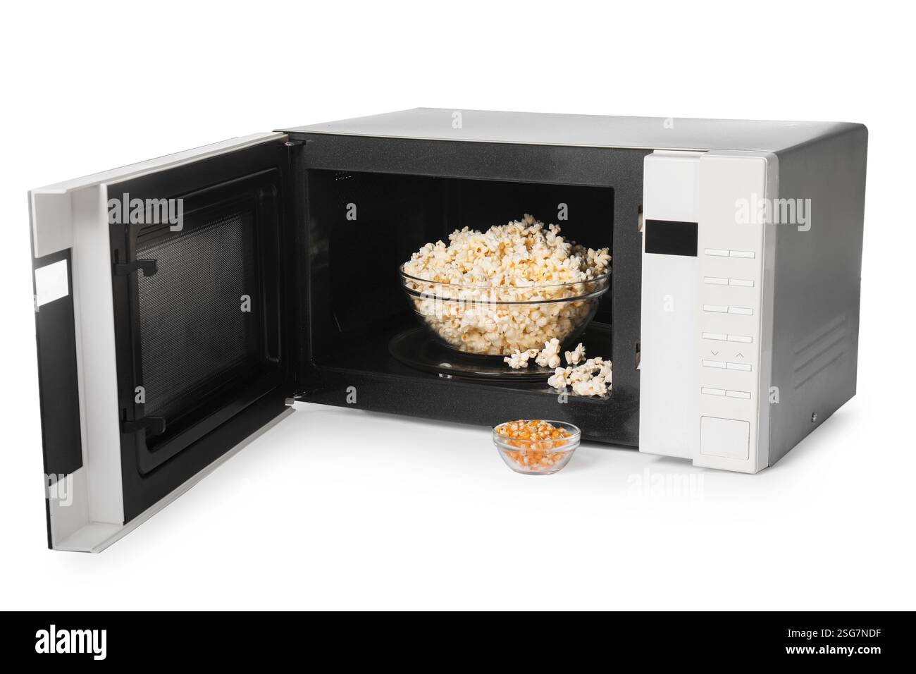 Open microwave oven with bowl of popcorn and kernels isolated on white ...