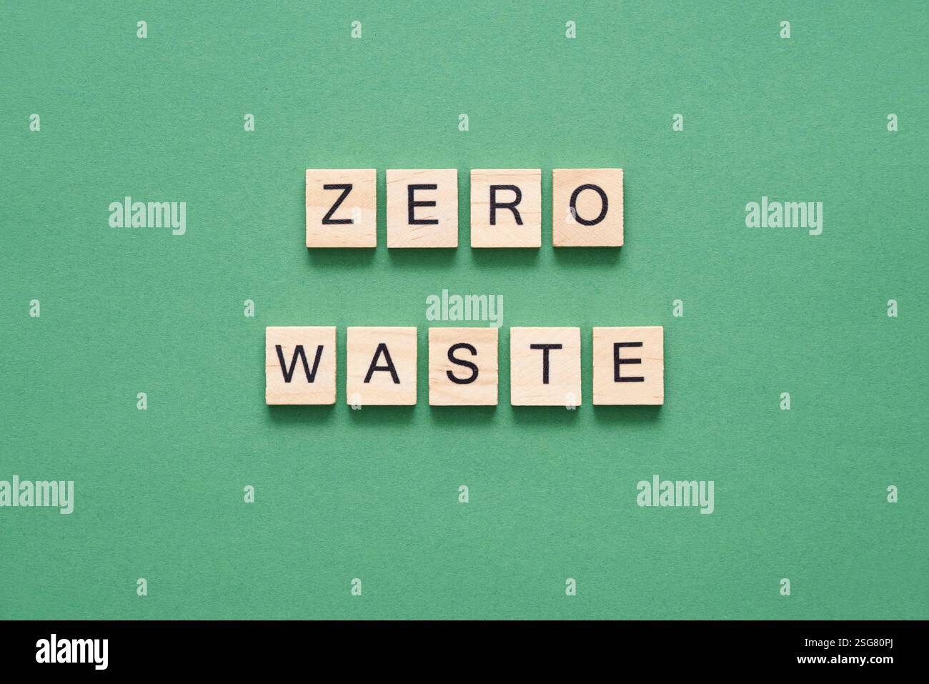 Wooden pieces with letters form, on a green background, a message of ...