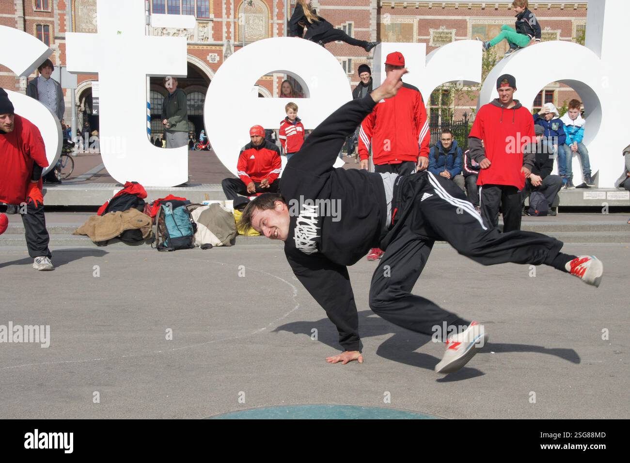 The energetic performers showcase their impressive moves, freezing in ...