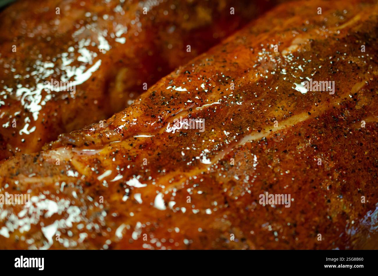Grilling spare ribs on the barbeque. Delicious meat prepared with sauce ...