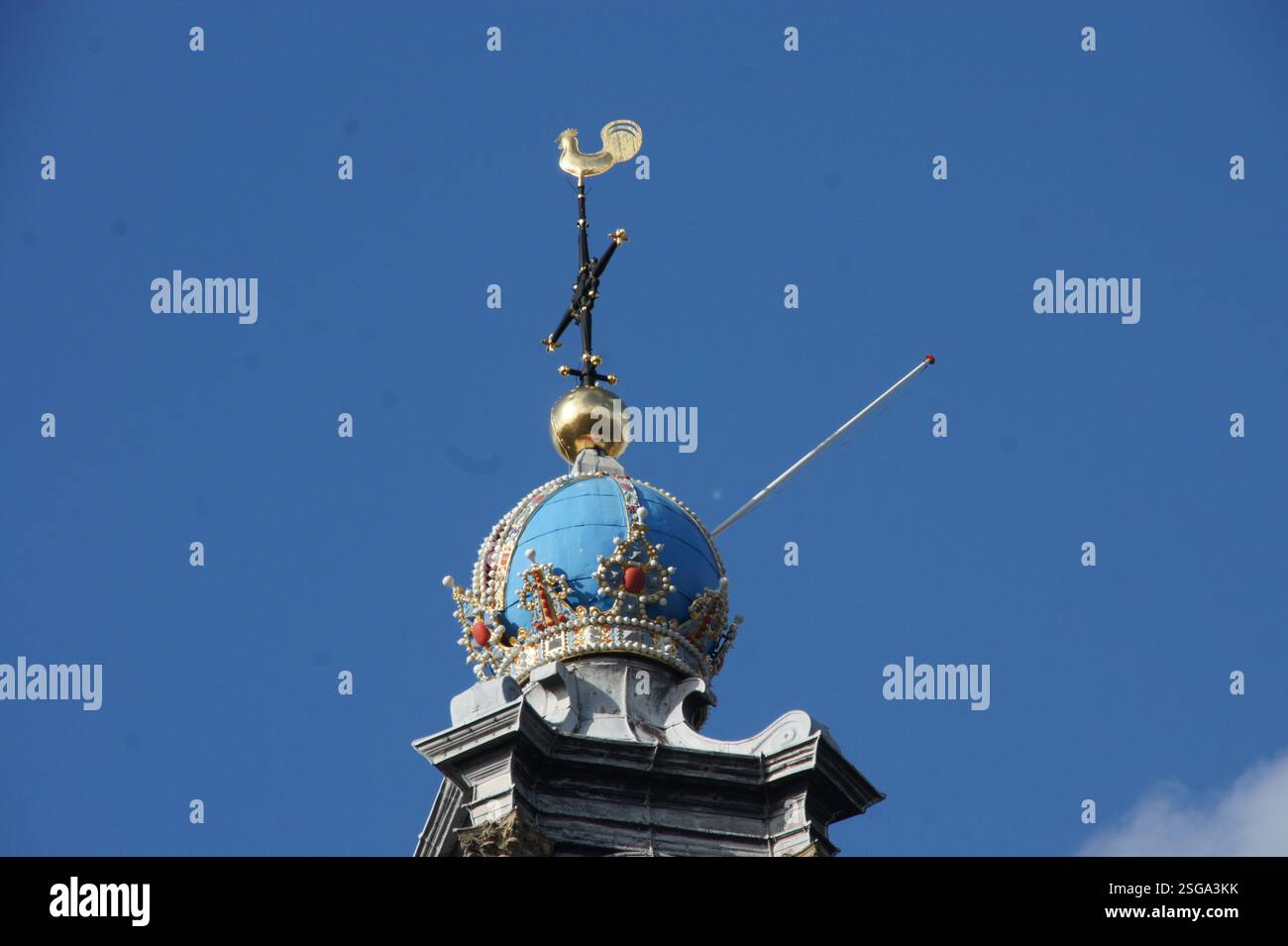 A golden weather vane adorns the blue dome atop a Westerkerk tower in ...