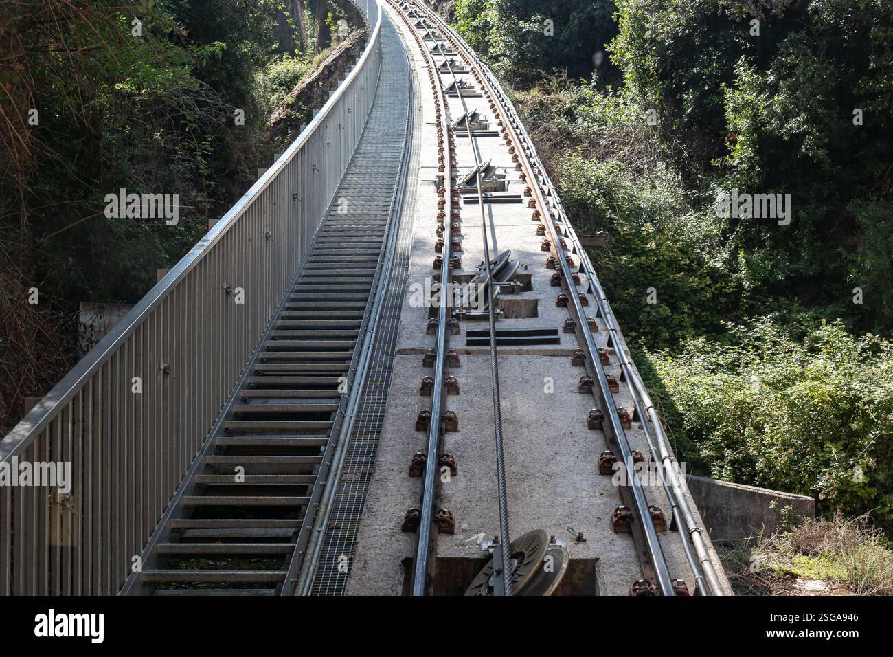 Elevated railway track of funicular or cable car around trees in Europe ...