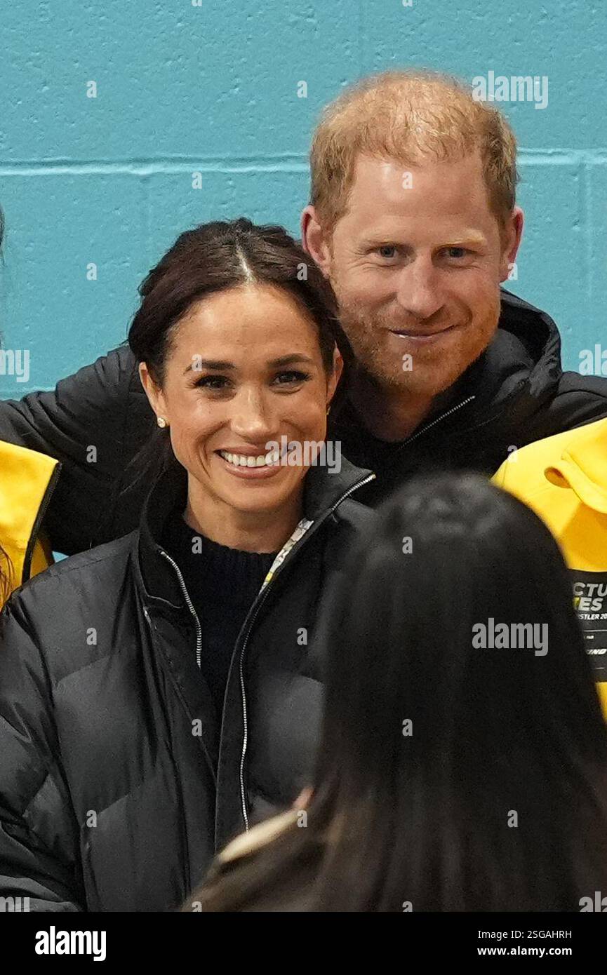 The Duke and Duchess of Sussex pose with fans for a picture after the ...