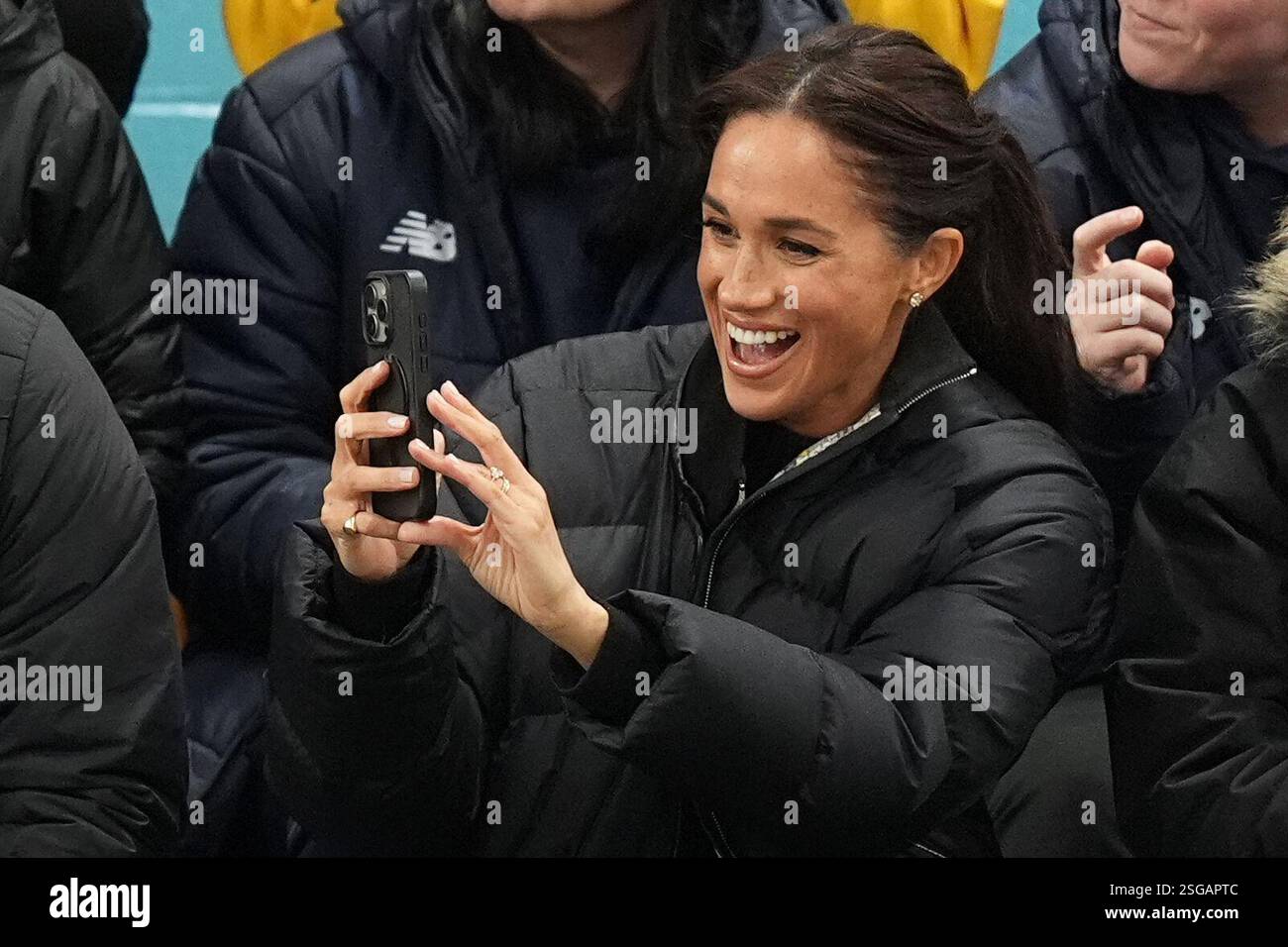 The Duchess of Sussex takes a picture while watching Wheelchair Curling ...