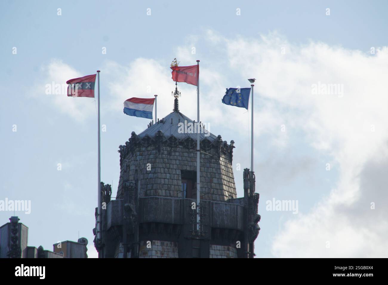 Tower with three flags fluttering in the wind, possibly a landmark in ...
